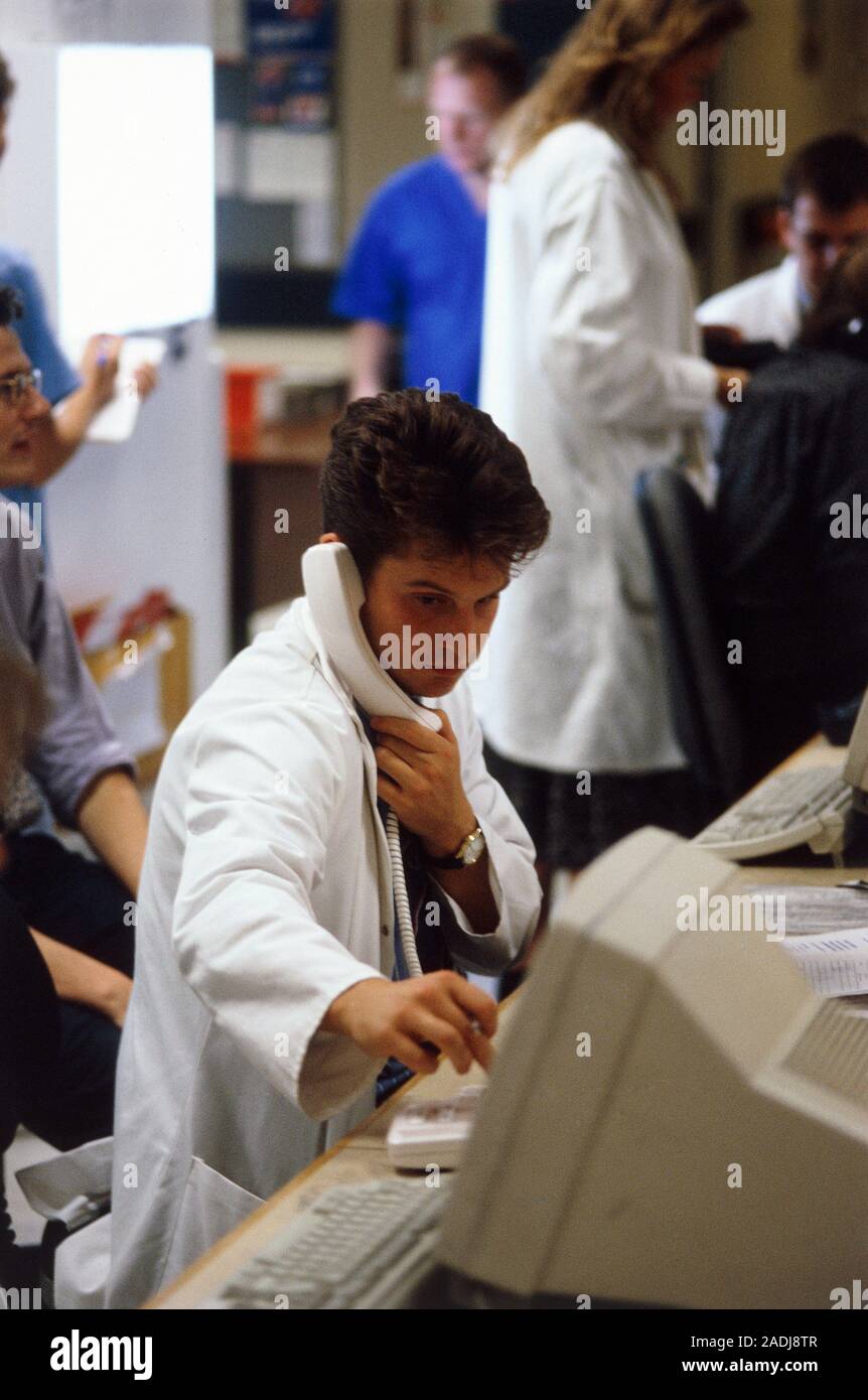 Hospital doctor using a telephone in an accident and emergency ...