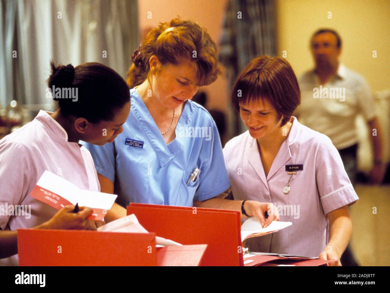 Hospital nurses reading patients' notes in an accident and emergency ...