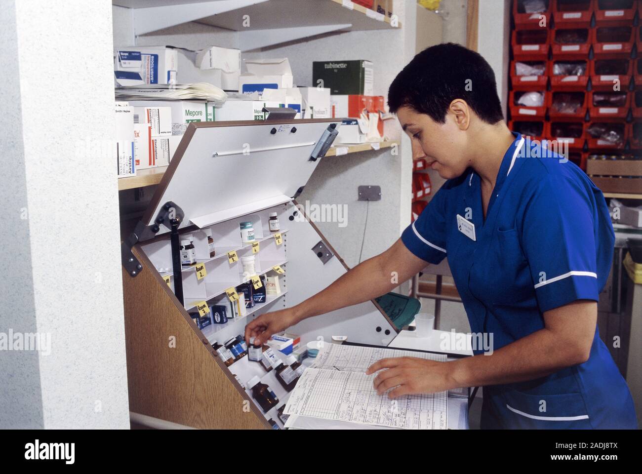 Hospital nurse taking an inventory of medical drugs. Compartments in ...