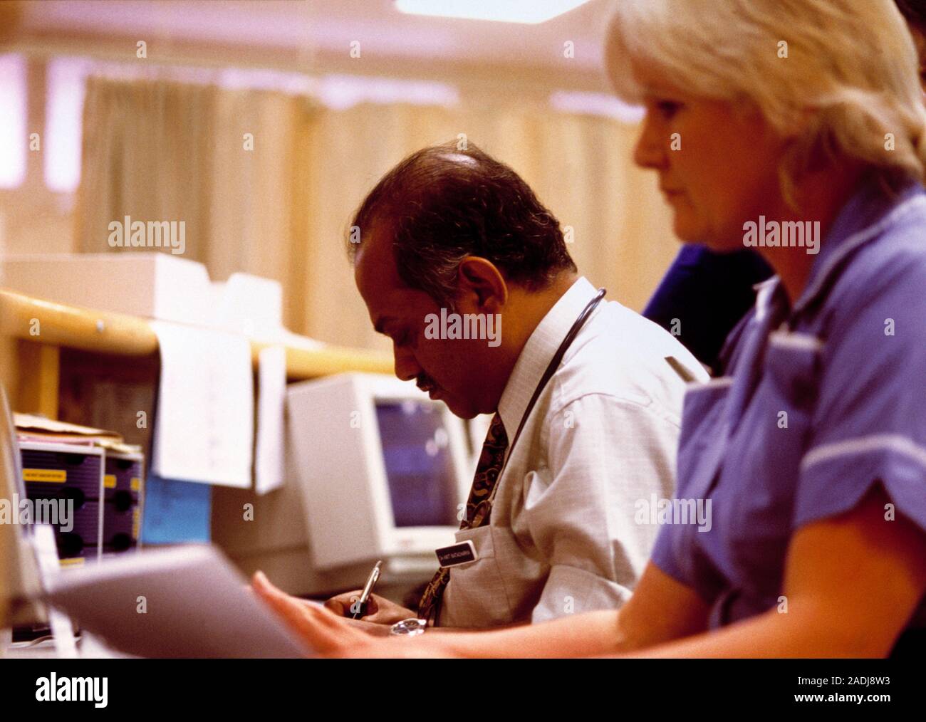 Hospital doctor & nurse working on paperwork in a casualty department ...