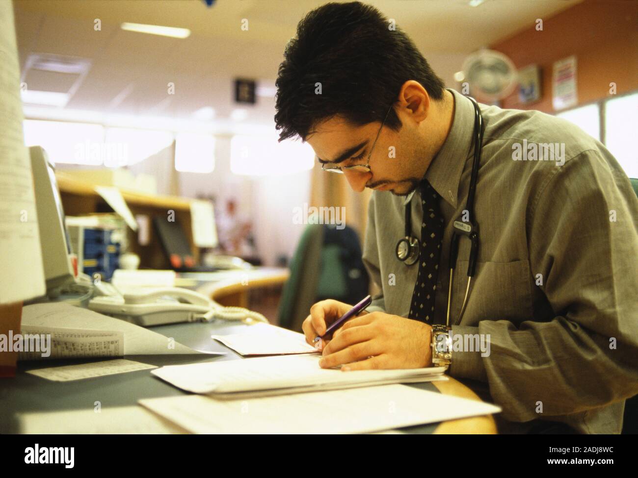 Hospital doctor writing notes in an accident and emergency department ...