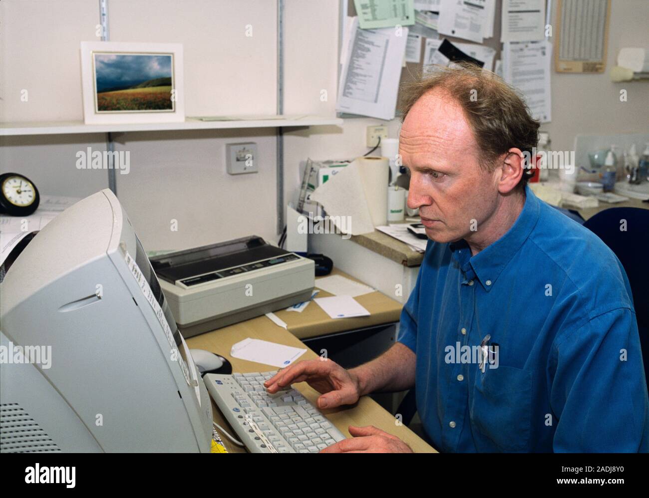 Doctor using a computer in his surgery. Photographed at Maywood Surgery ...