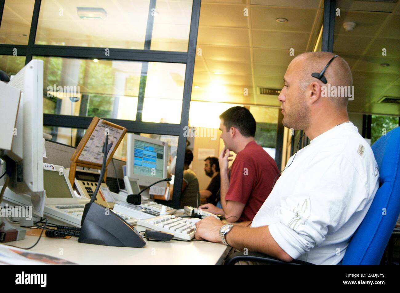 Emergency control room. Operators answering calls in a French emergency services control room ...