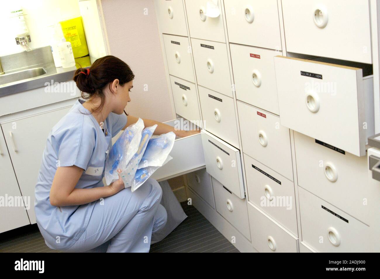 Hospital nurse storing new medical equipment. Photographed at the ...