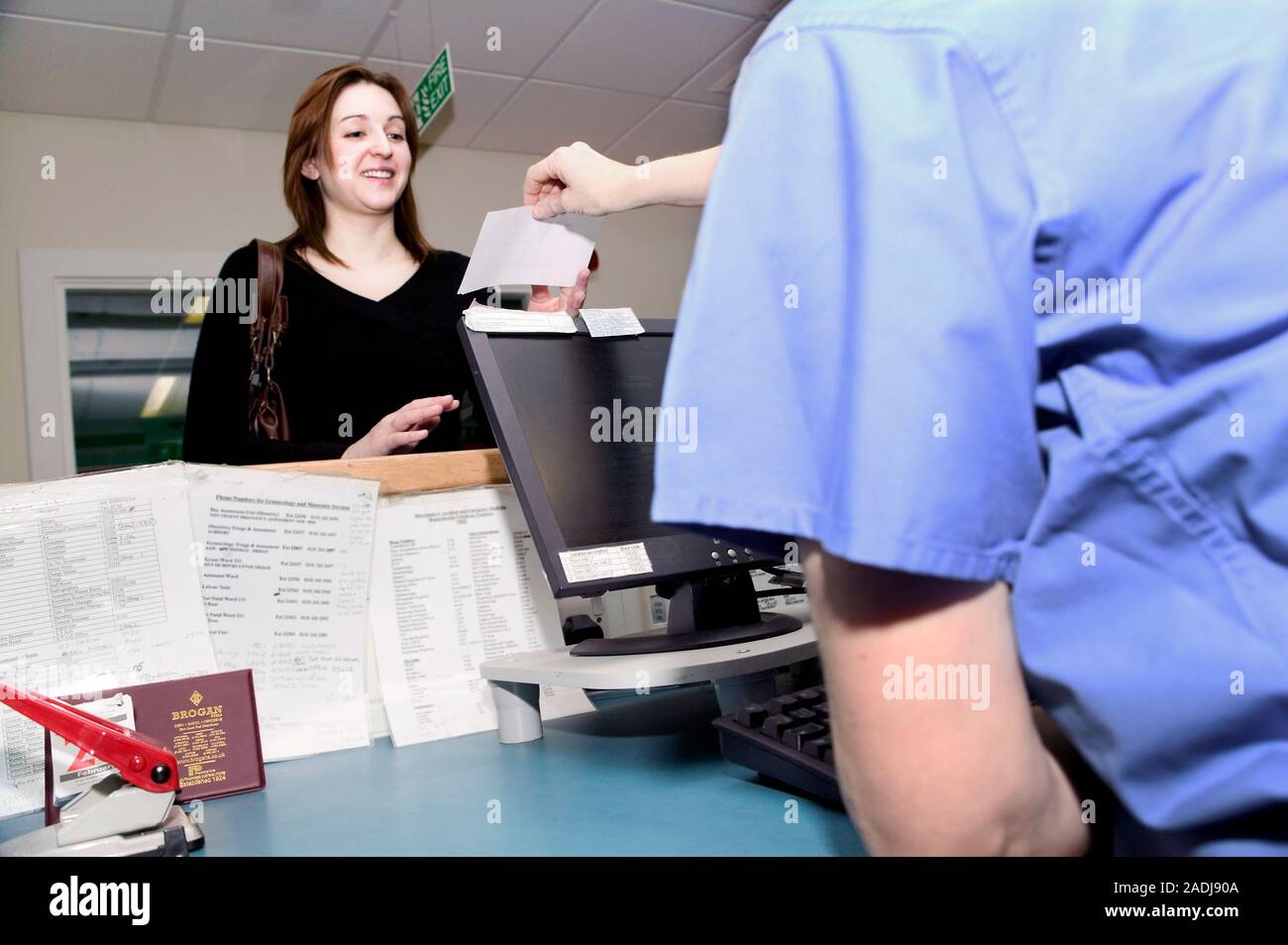 MODEL RELEASED. Reception. Patient at reception in Accident and ...