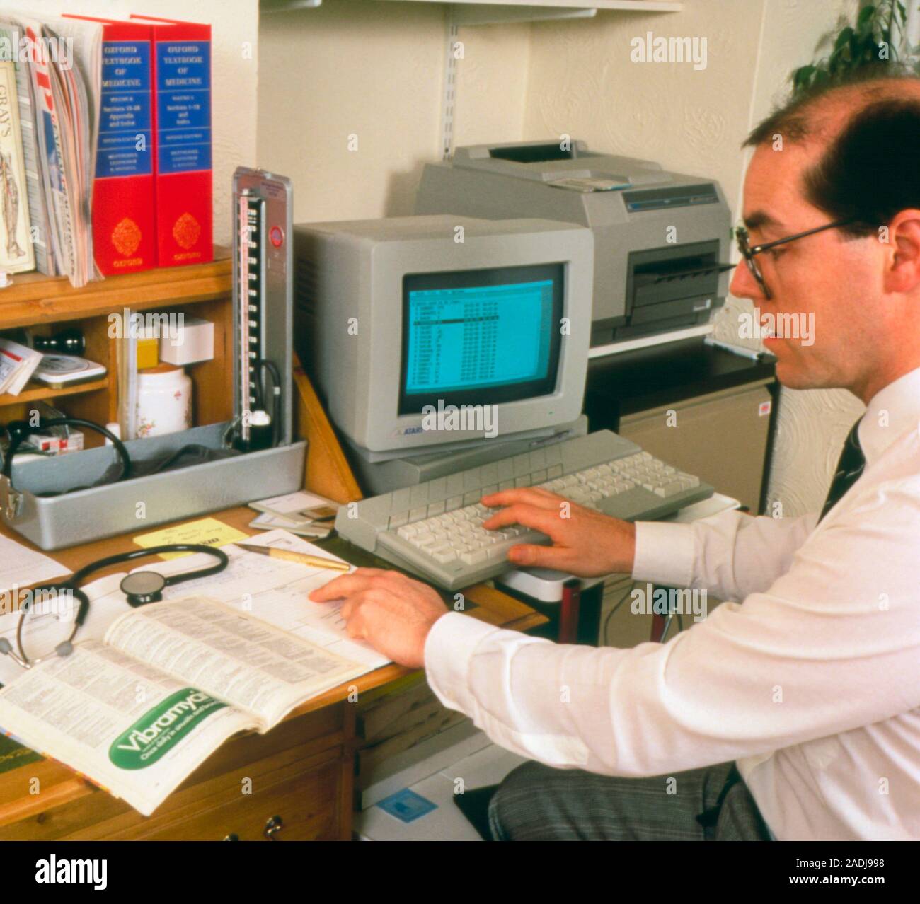 General practice (GP) doctor using computerised patient records system ...