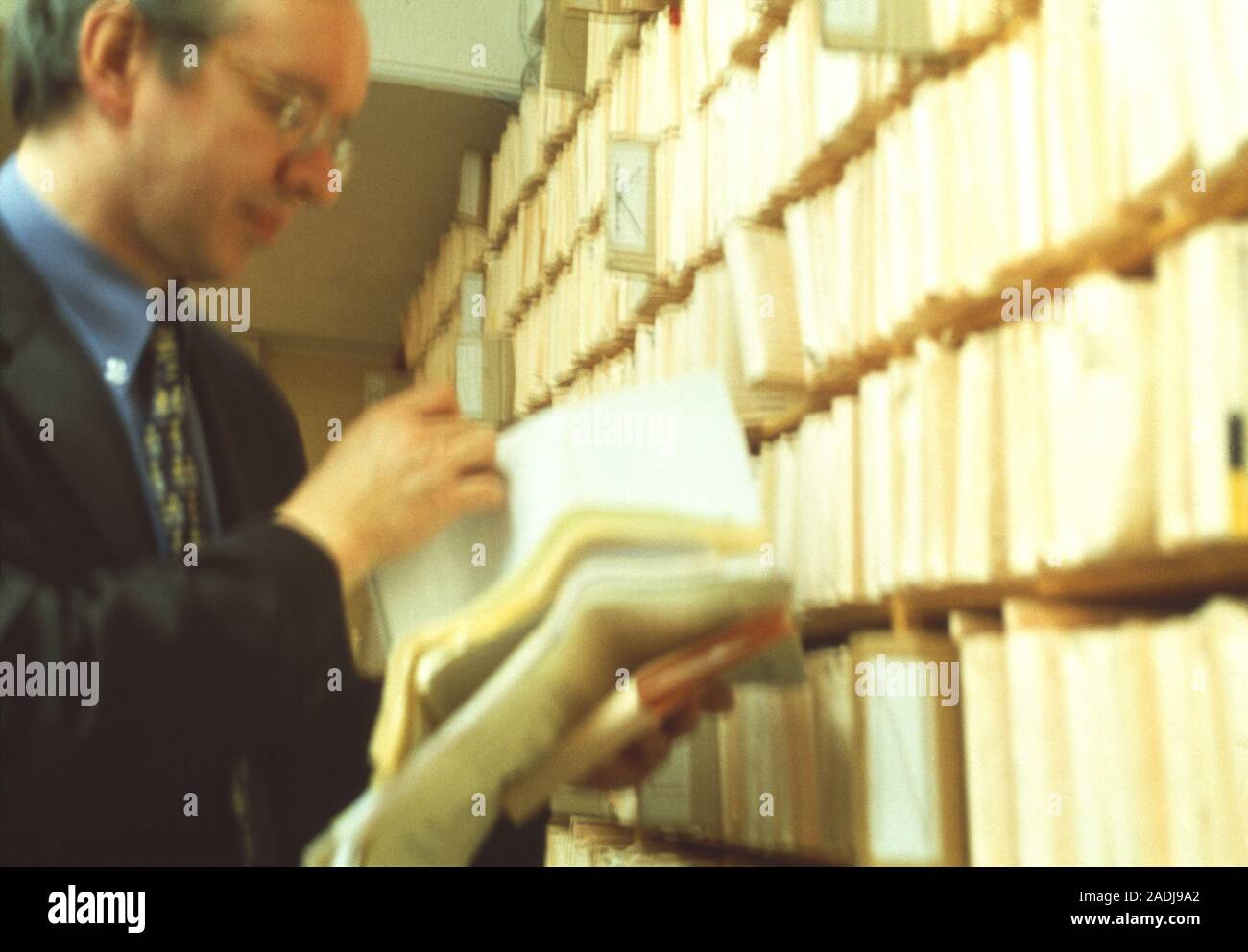 Medical records. Doctor examining medical records in his surgery Stock ...