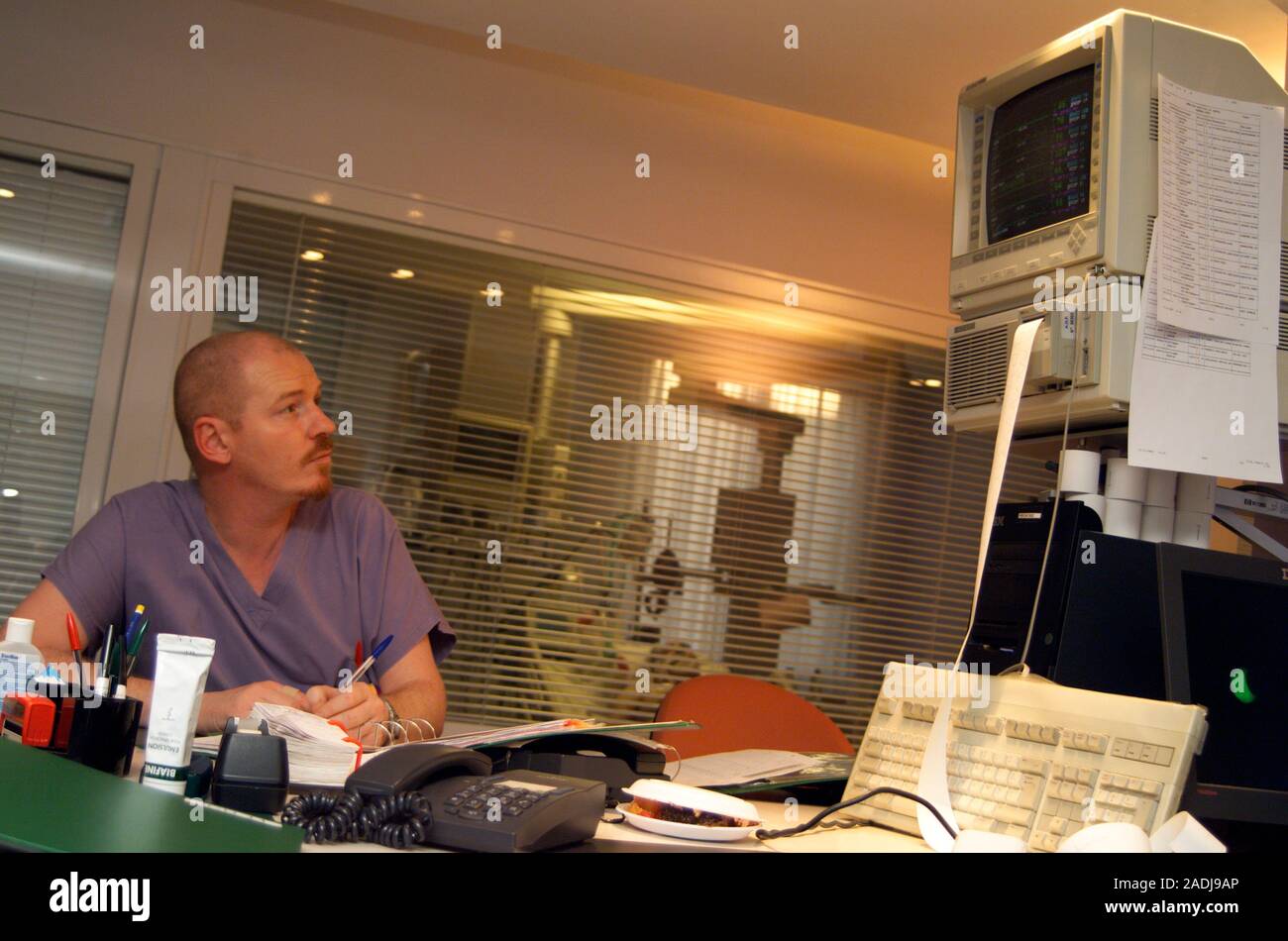 Medical records. Nurse filling in the medical records of a patient on a ...