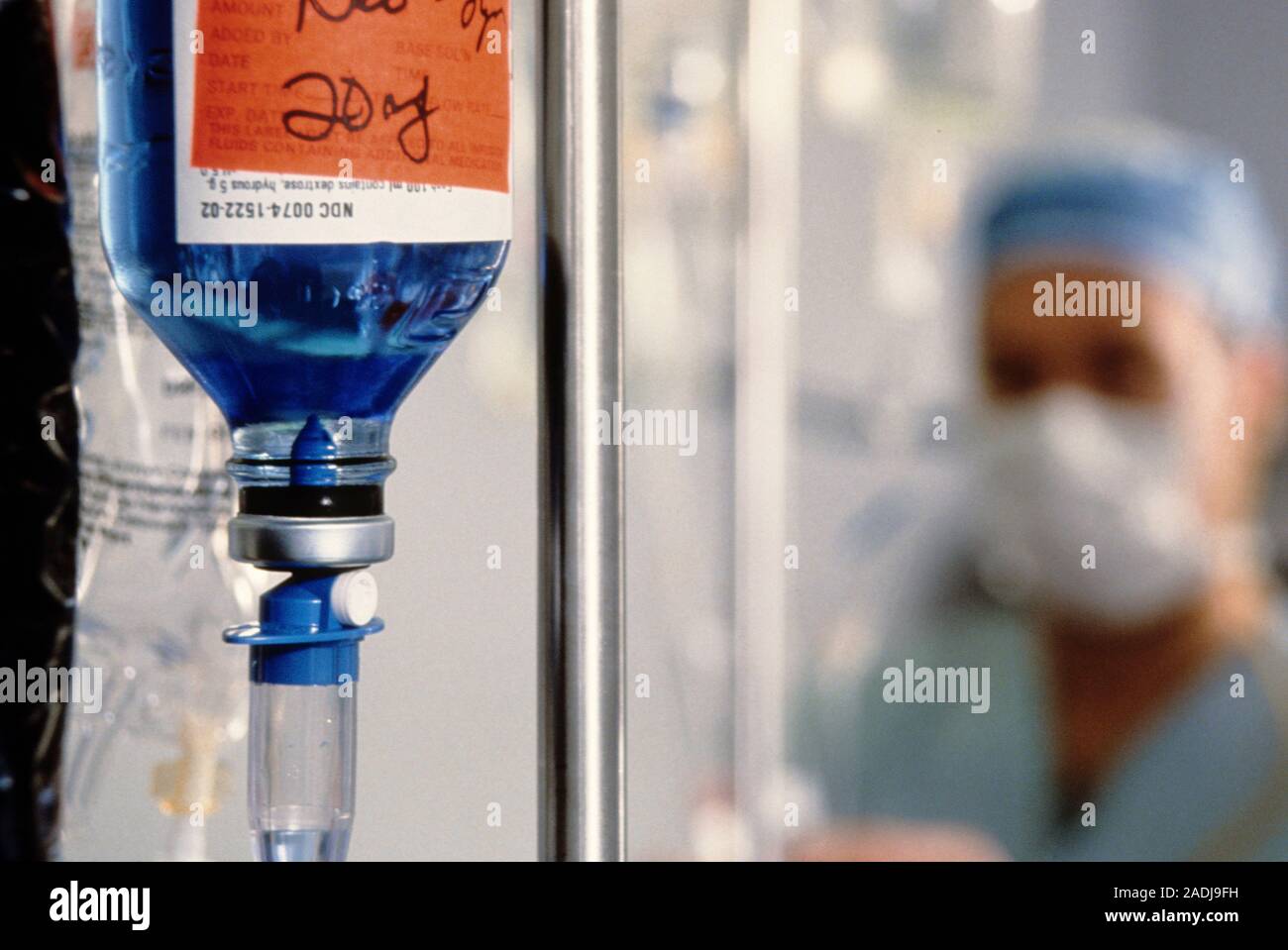 Intravenous drip in use during a surgical operation. The surgeon in the ...