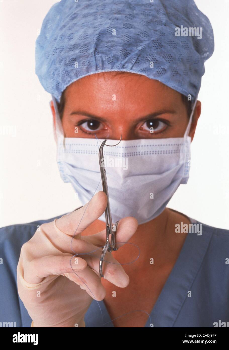 Surgeon With Suture View Of A Female Surgeon Holding A Needle With A
