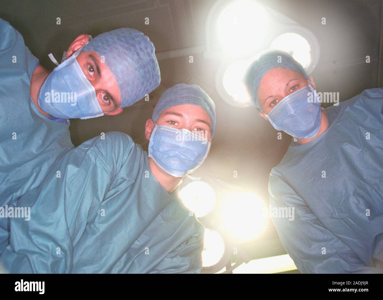 Surgery. Patient's-eye view of a surgical team in an operating theatre ...