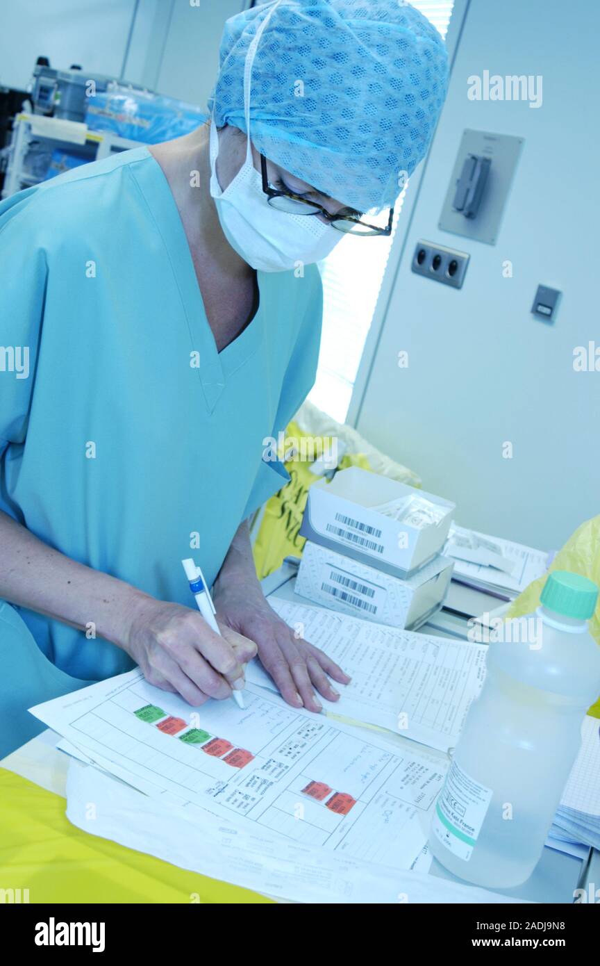 Nurse in an operating theatre. Nurse taking notes, listing material ...
