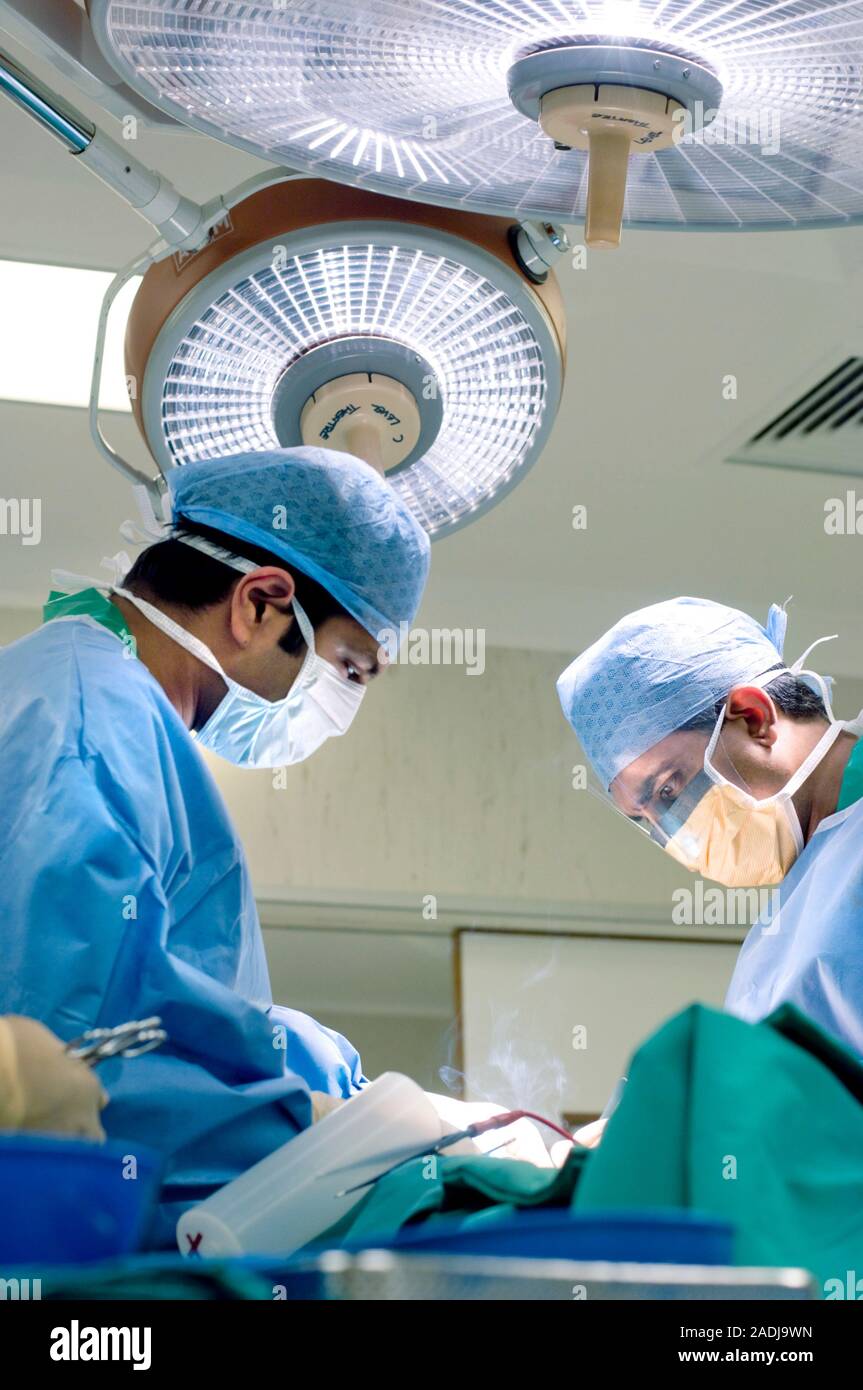 MODEL RELEASED. Surgeons operating. Surgical team carrying out an ...