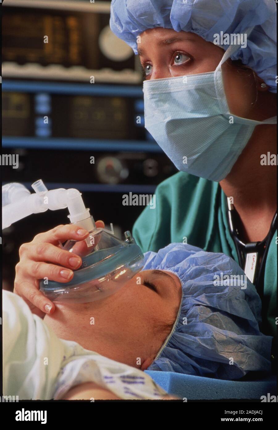 Portrait of an anaesthetist at work, showing her administering gas ...