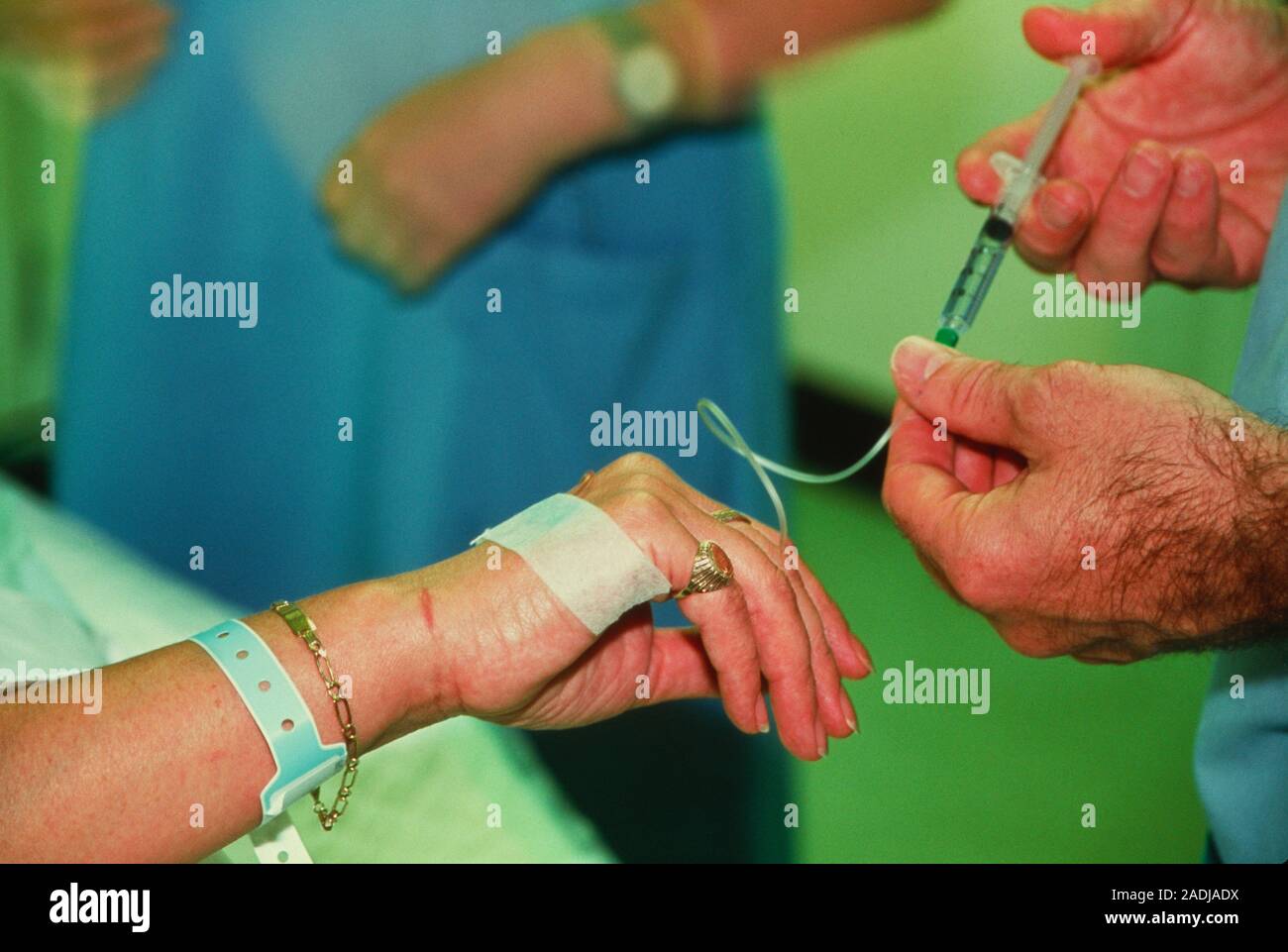 General anaesthetic. Hand injecting a general anaesthetic into a ...