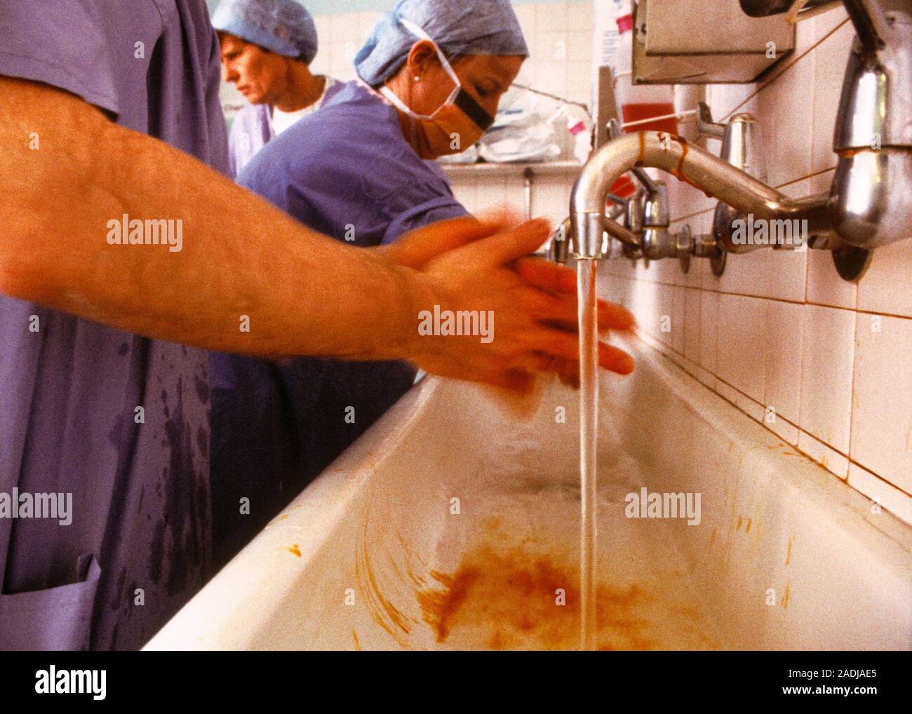 Surgeons scrub hands. Pre- operative hygiene in which surgeons and ...