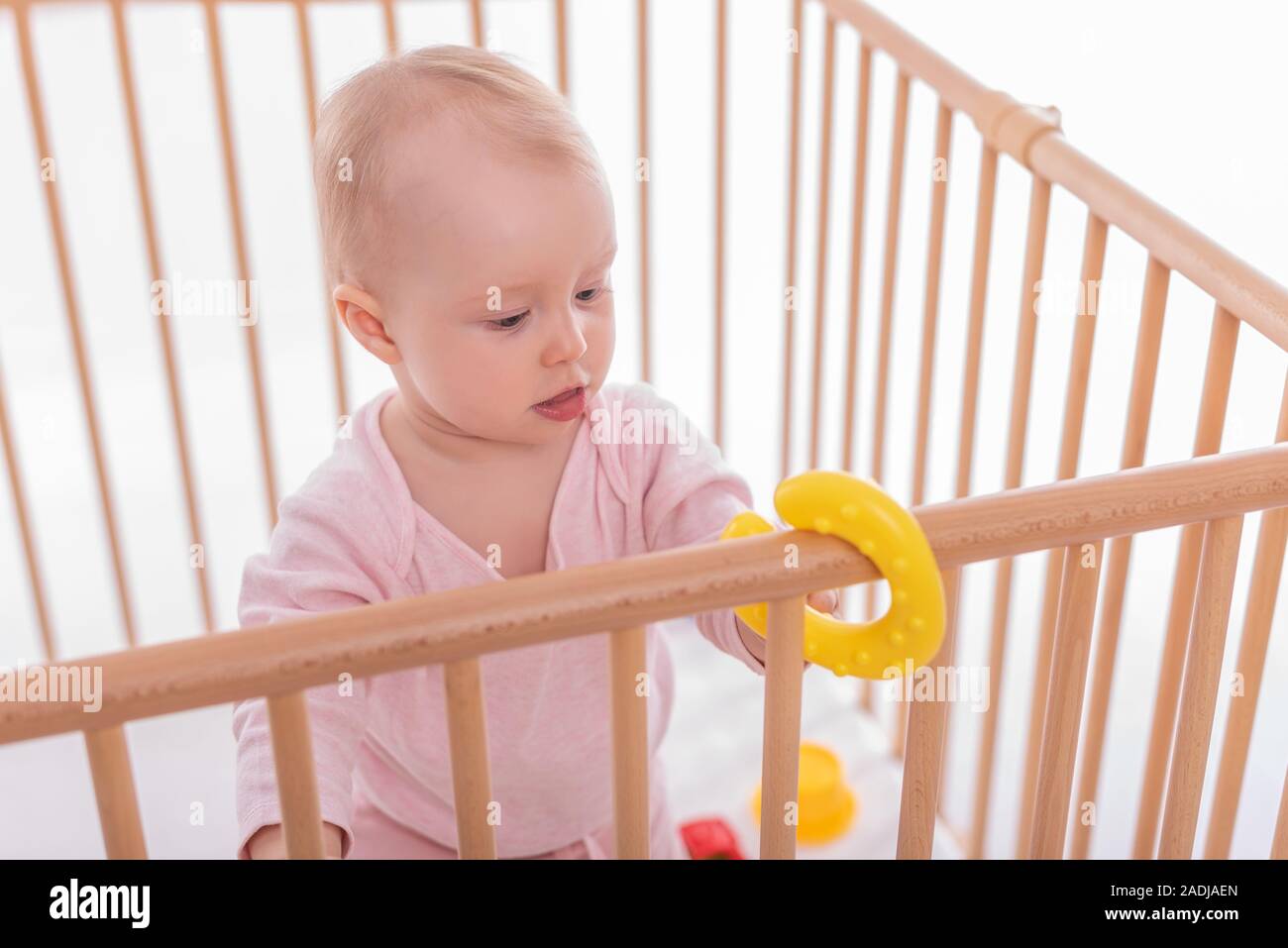 Baby girl at children's playpen Stock Photo - Alamy