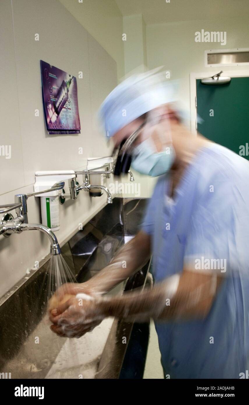 Preparing for surgery. Surgeon washing his hands before surgery ...