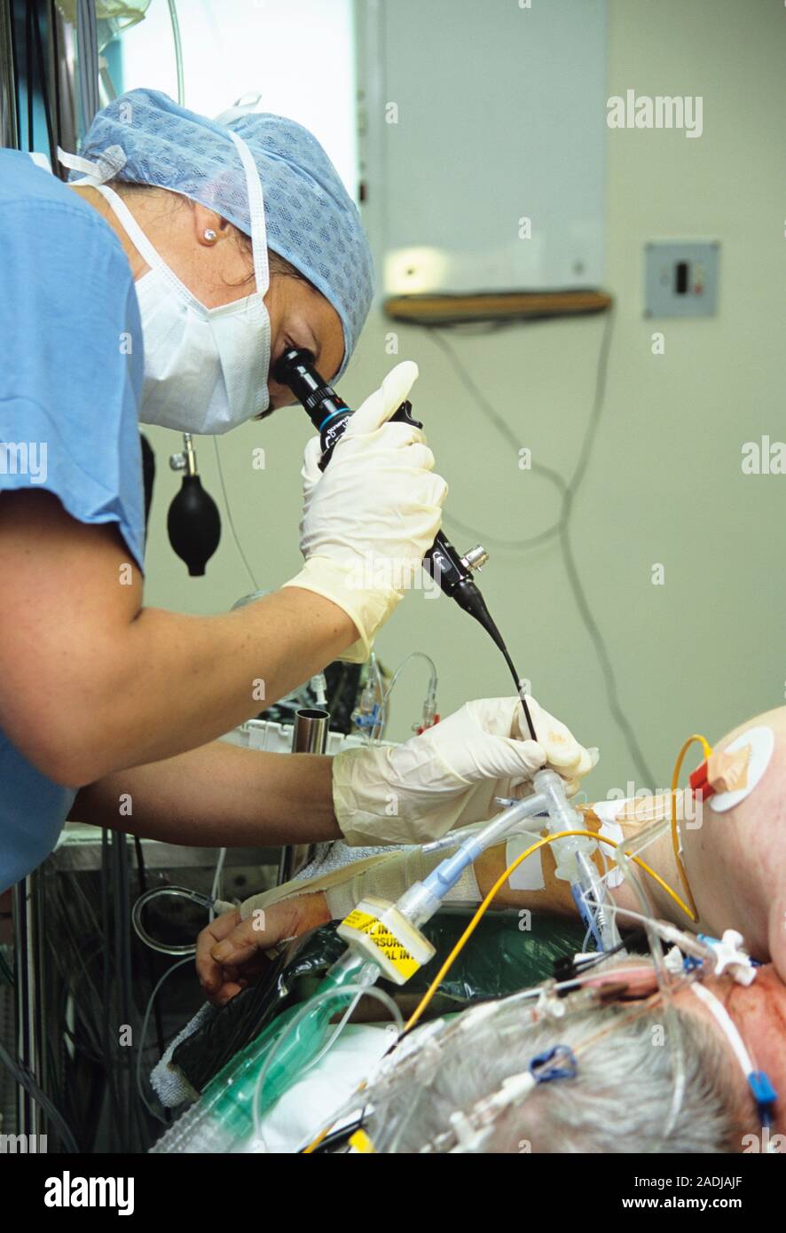 MODEL RELEASED. Surgery preparation. Anaesthetist checking the ...