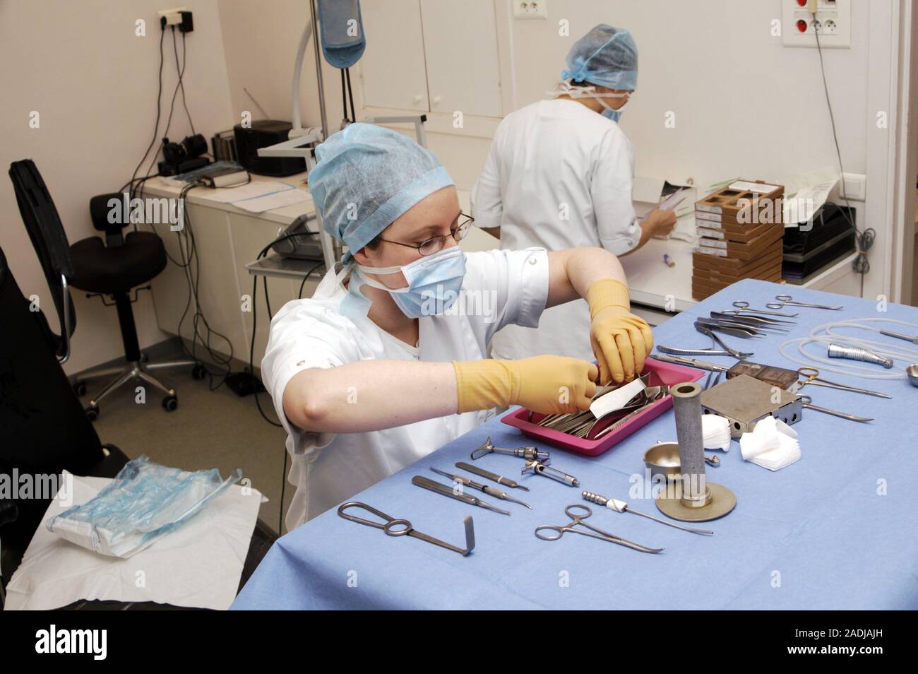 Surgical equipment. Theatre assistants setting up an operating theatre ...