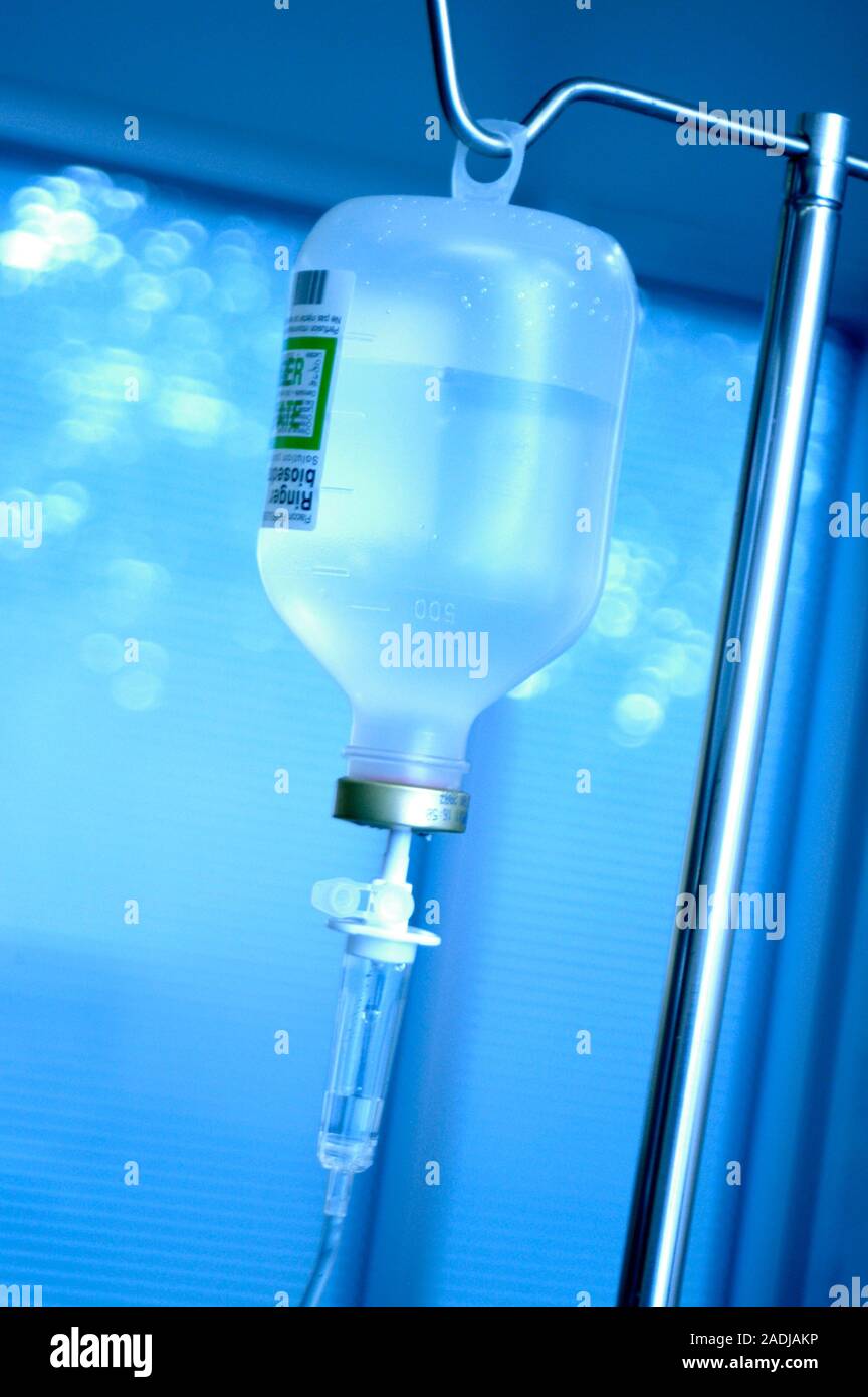 Anaesthetic drip. Bottle containing an anaesthetic drug, attached to an ...