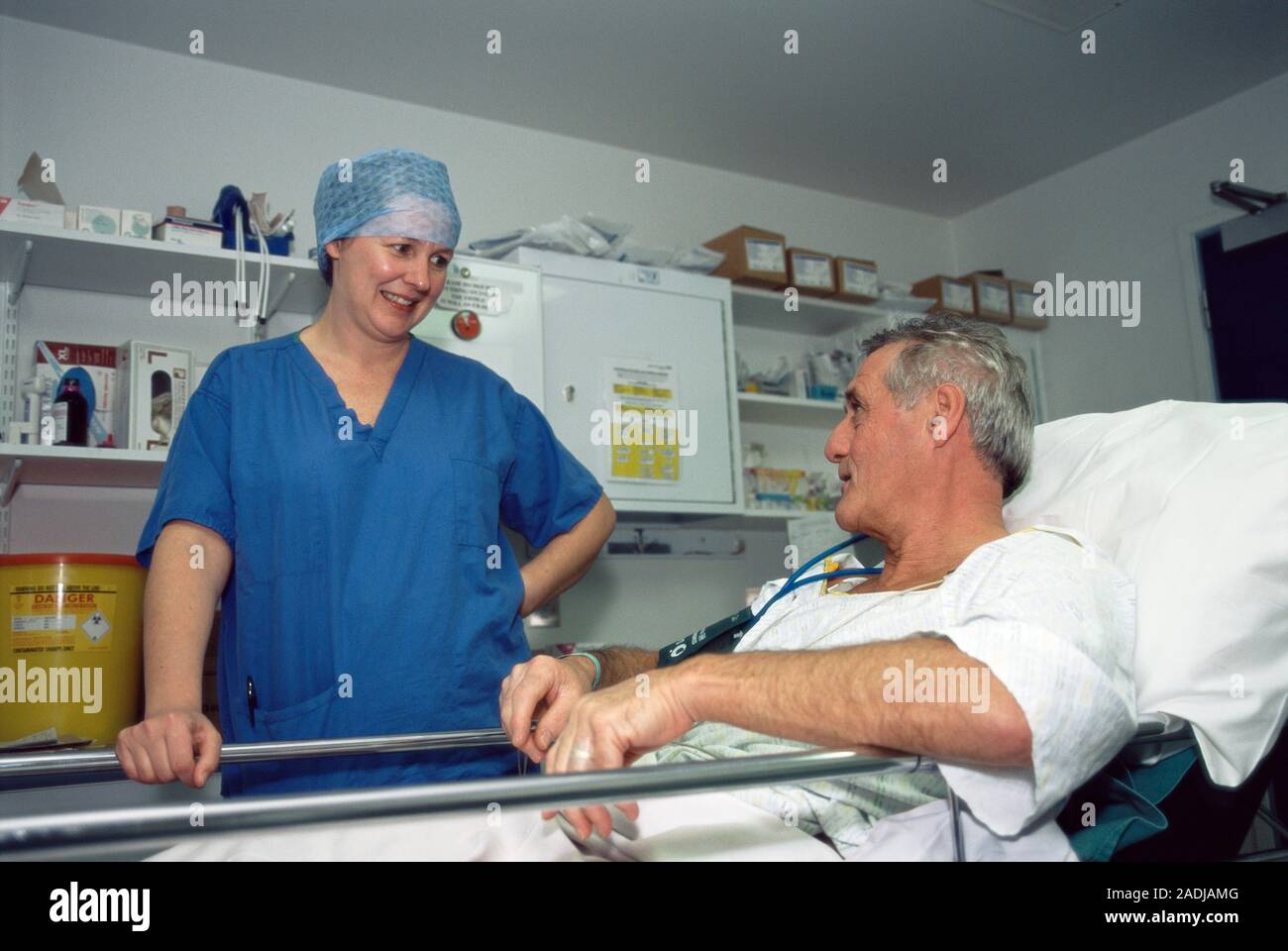 Preparing for surgery. Nurse talking to a patient before surgery. The ...