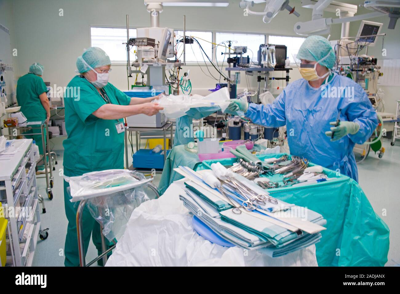MODEL RELEASED. Preparing for surgery. Theatre assistants setting up an ...