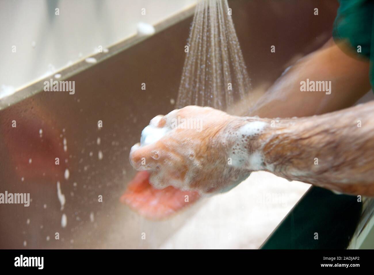 MODEL RELEASED. Preparing for surgery. Surgeon scrubbing up before ...