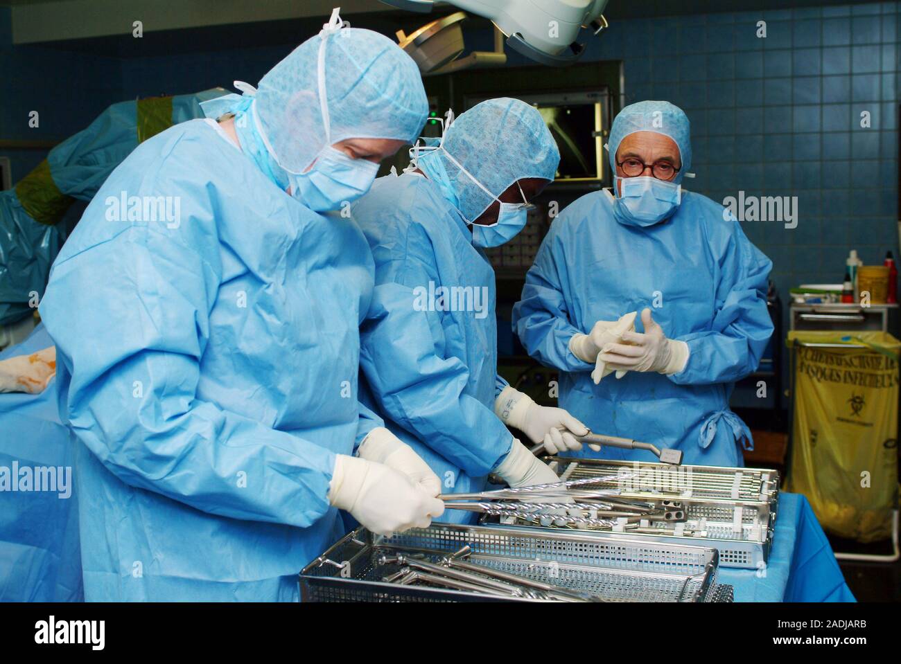 Preparing for surgery. Theatre team selecting instruments for ...