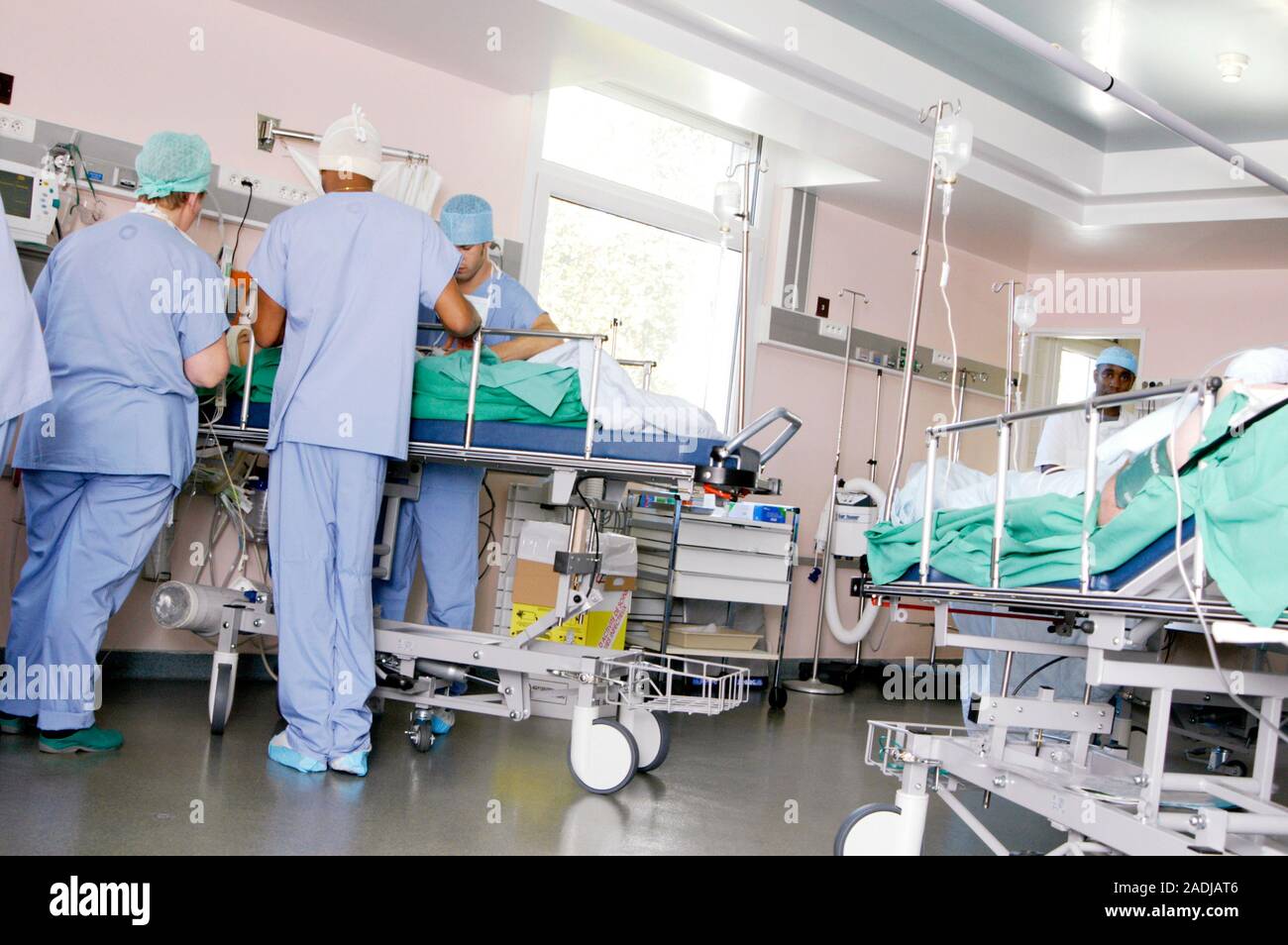 MODEL RELEASED. Post-operative care. Doctor and nurses attending to a ...