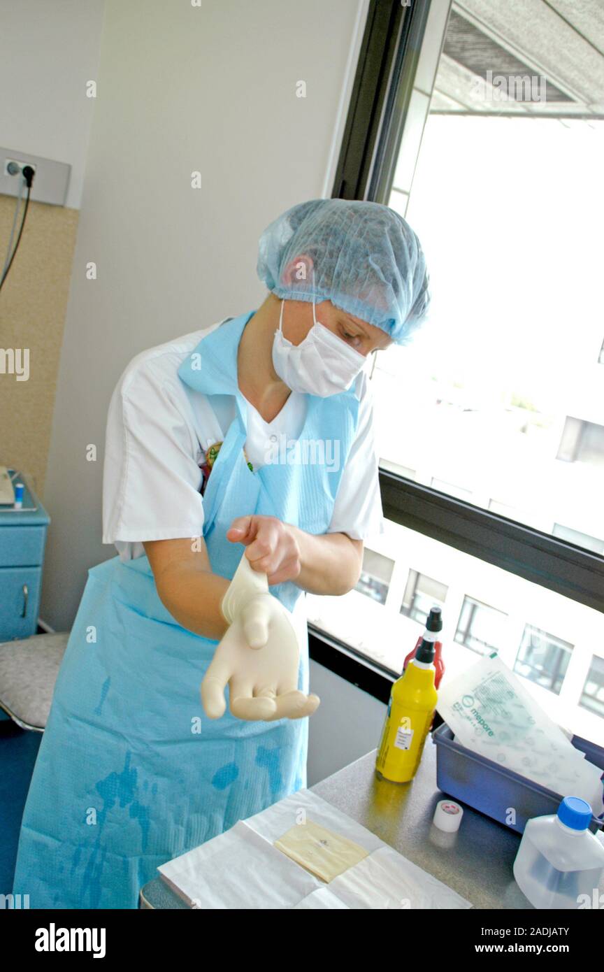 Post-operative hospital care. Nurse preparing to clean a patient's ...