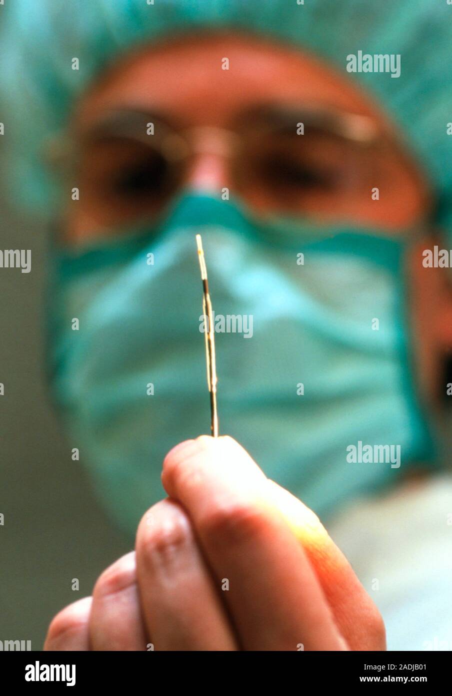 Heart artery implant. Surgeon holds an intraluminal stent which will be ...
