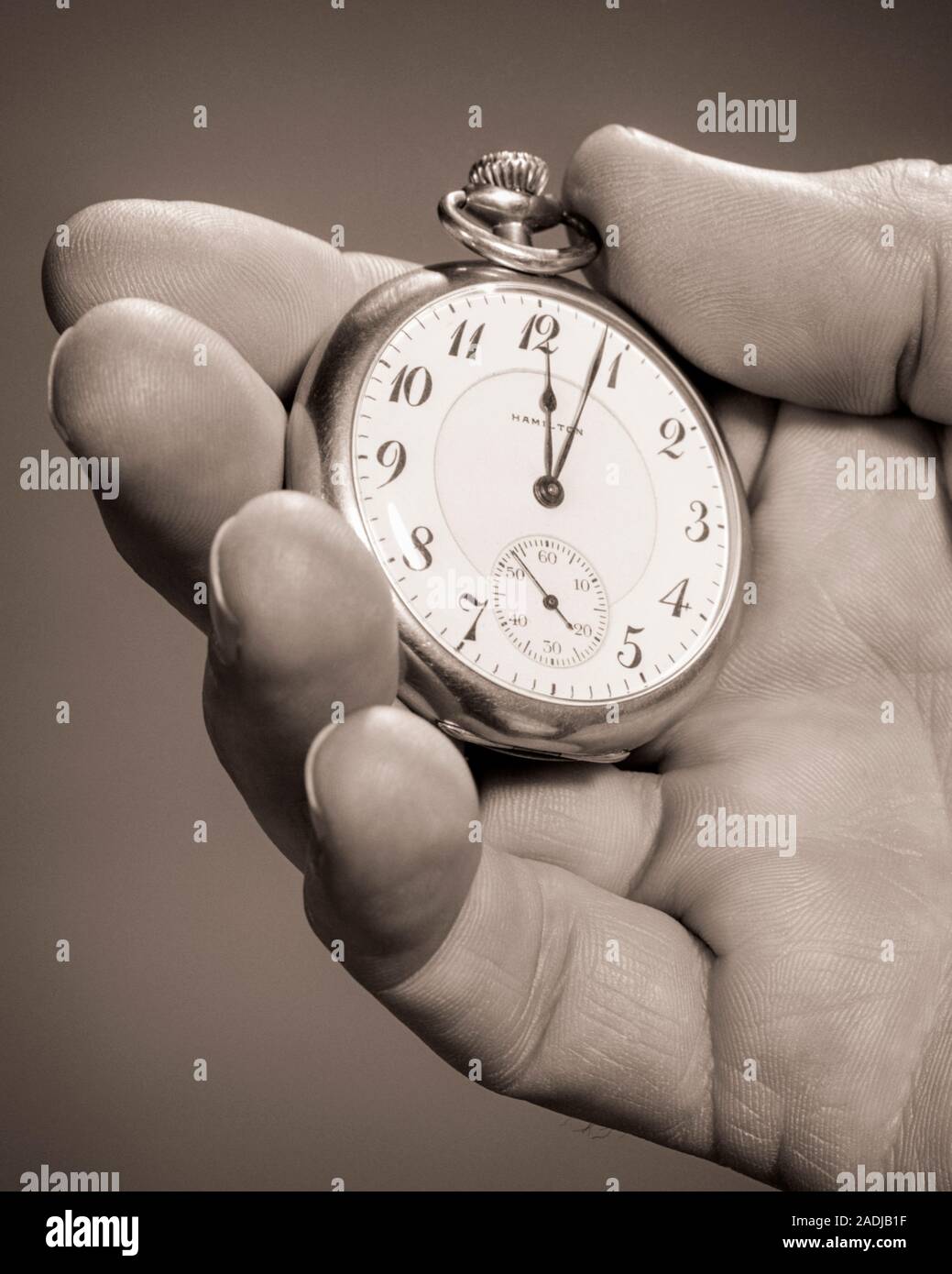 1960s MALE HAND HOLDING POCKET WATCH FOUR MINUTES PAST NOON OR MIDNIGHT ...