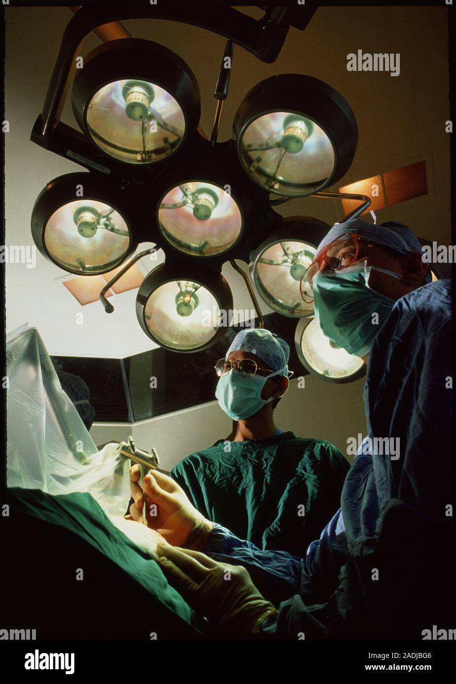 Robot-aided surgery. Neurosurgeon uses a computer- controlled robot arm ...