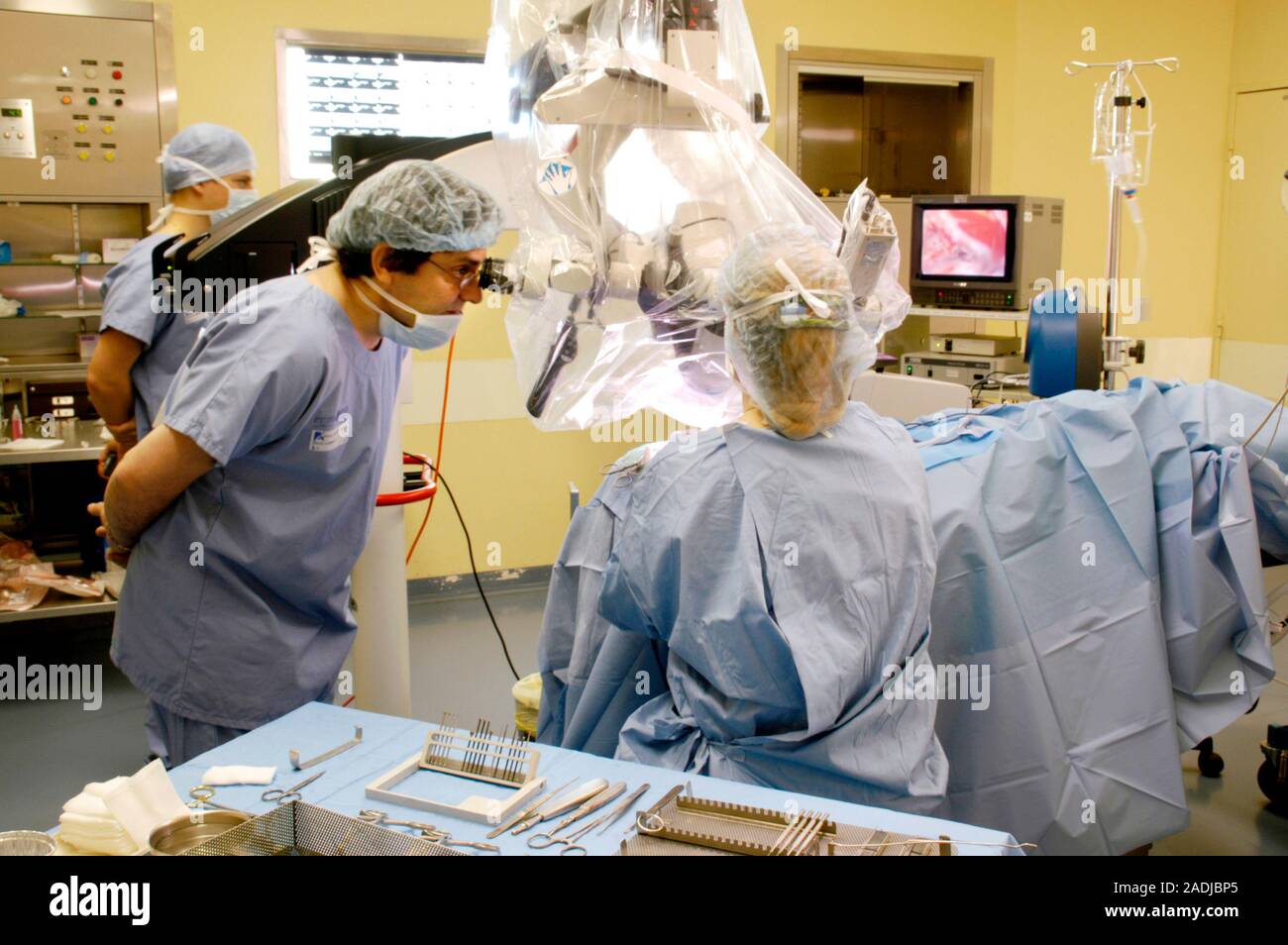 Cochlear implant surgery. Surgeon using a microscope during cochlear ...
