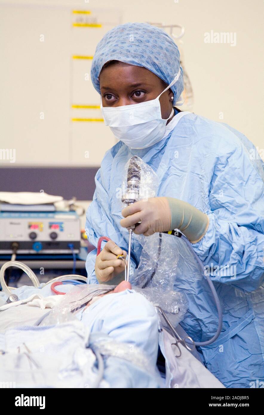 Sinus surgery. Surgeon using an endoscope (centre) during functional ...