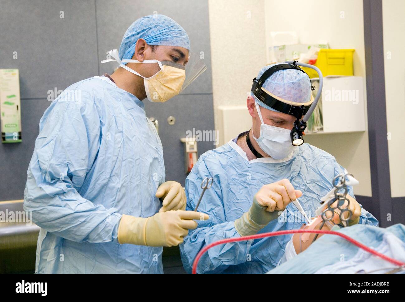 Tonsillectomy. Surgeons performing a tonsillectomy (tonsil removal ...