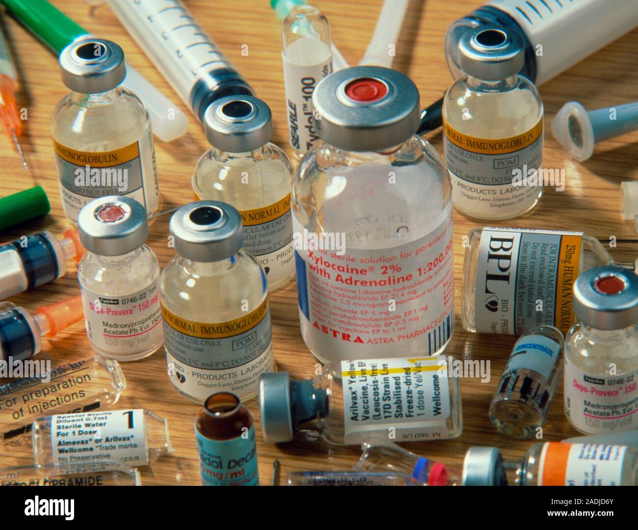 Drug vials and syringes. An assortment of used glass vials (phials ...