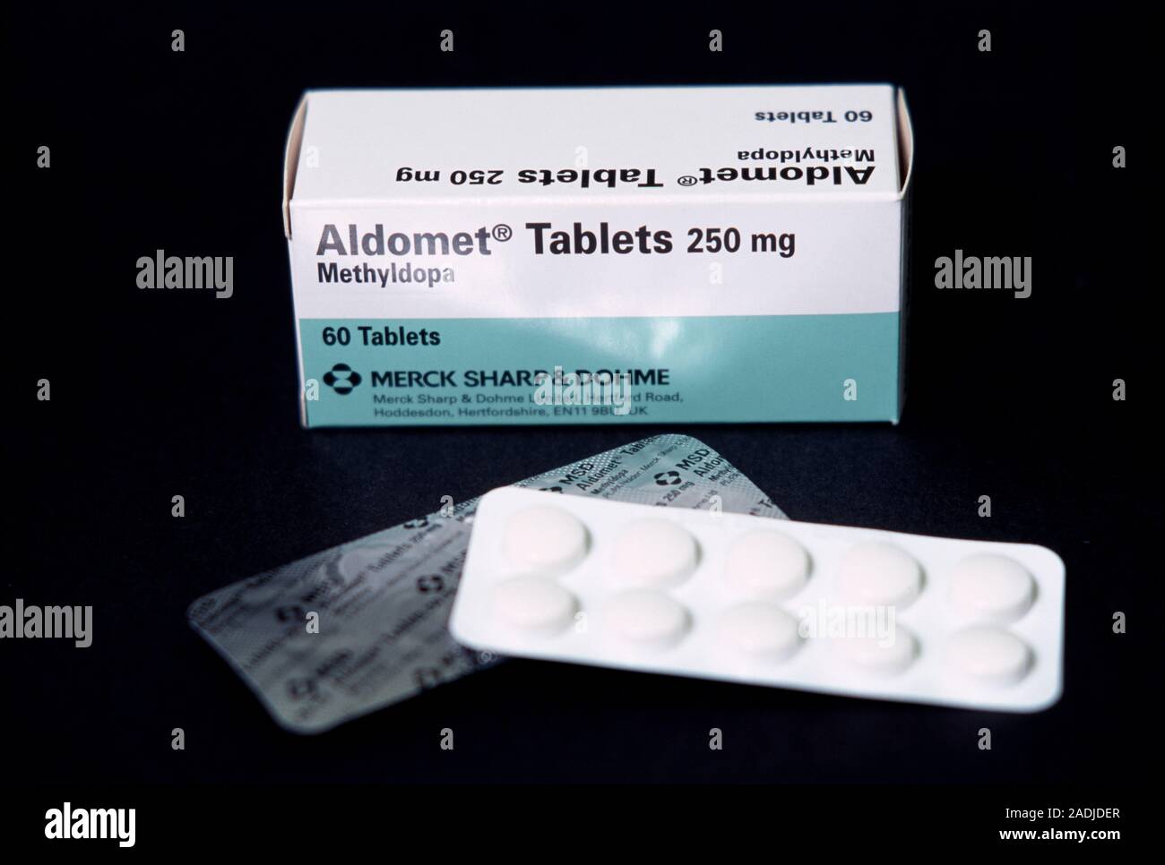 Antihypertensive drugs. Box and blister packs of Aldomet pills used to ...