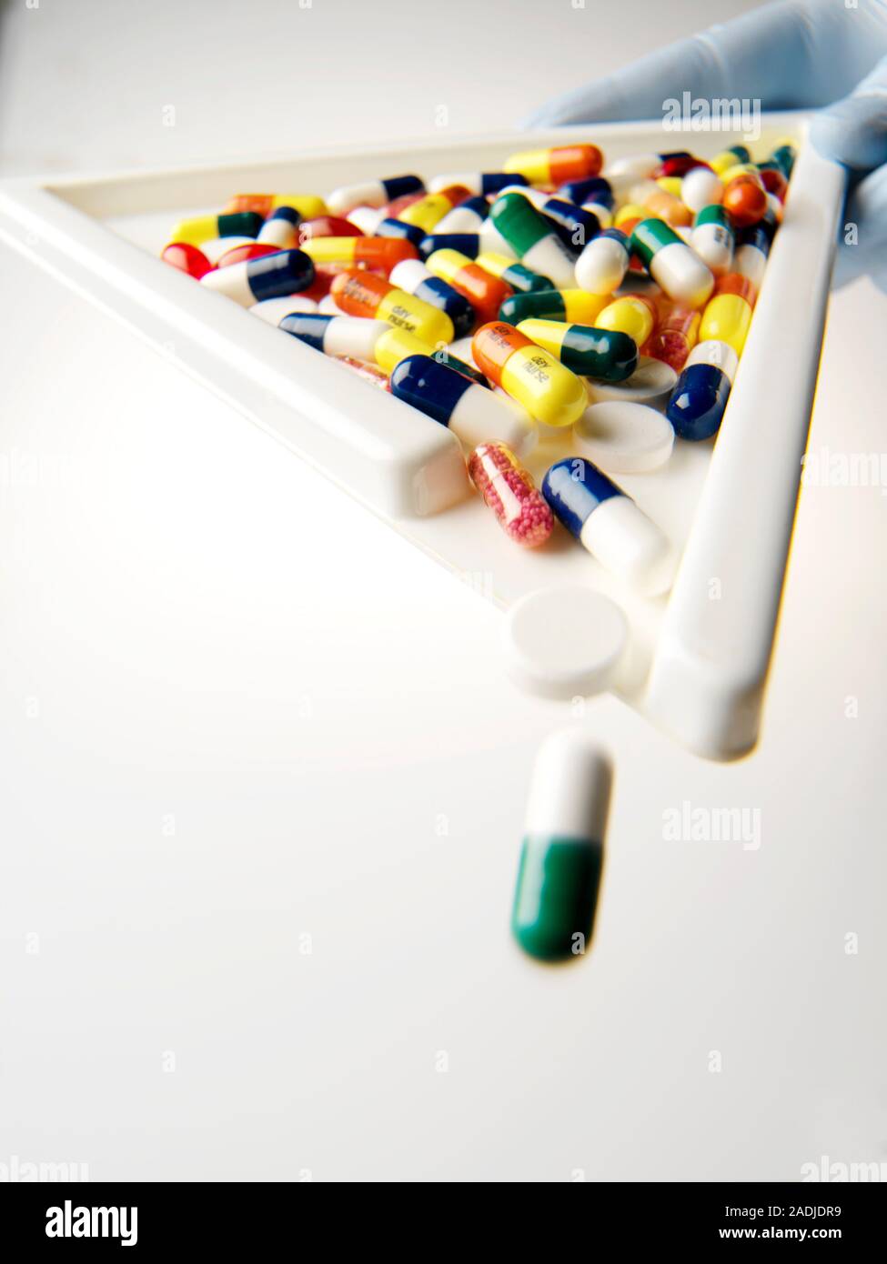 Medication. Doctor spilling assorted capsules and tablets from a ...