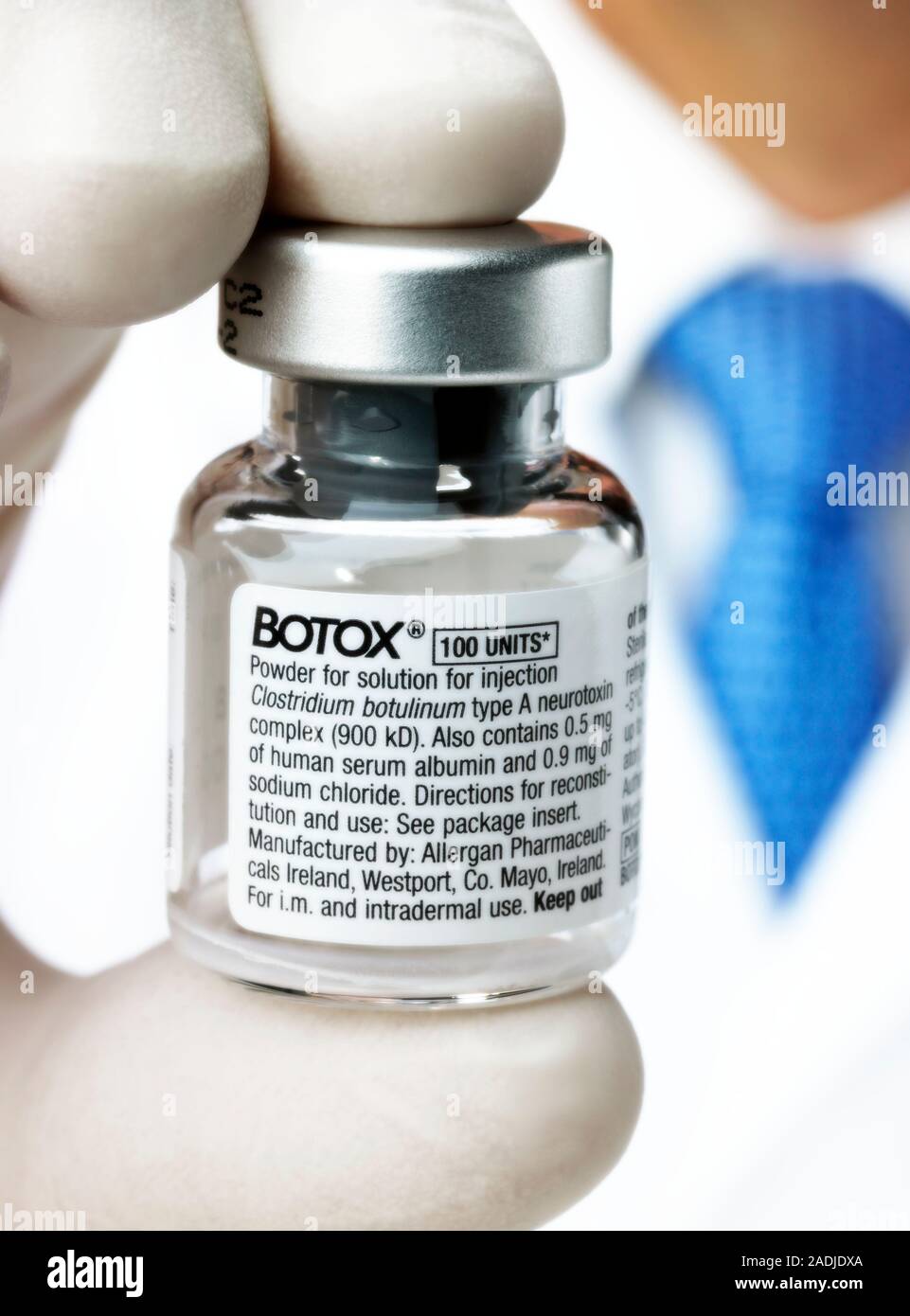 Botox cosmetic toxin. Clinician holding a bottle containing Botox ...