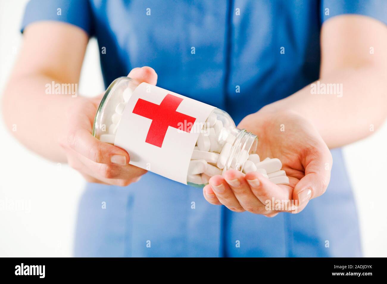 Jar of paracetamol pills. Nurse tipping paracetamol painkilling pills ...