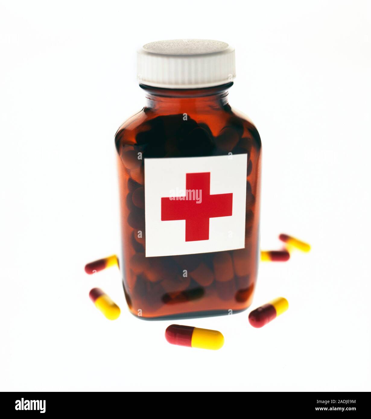 Bottle of pills bearing the red cross symbol Stock Photo - Alamy