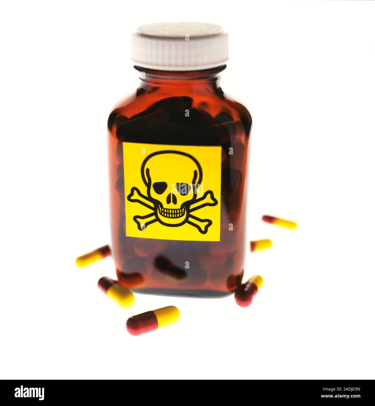 Toxic medication, conceptual image. Bottle of drug capsules bearing a ...