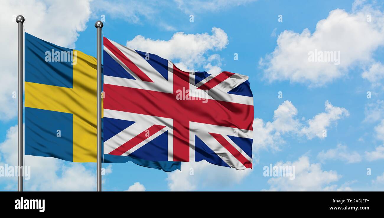 Sweden and United Kingdom flag waving in the wind against white cloudy ...