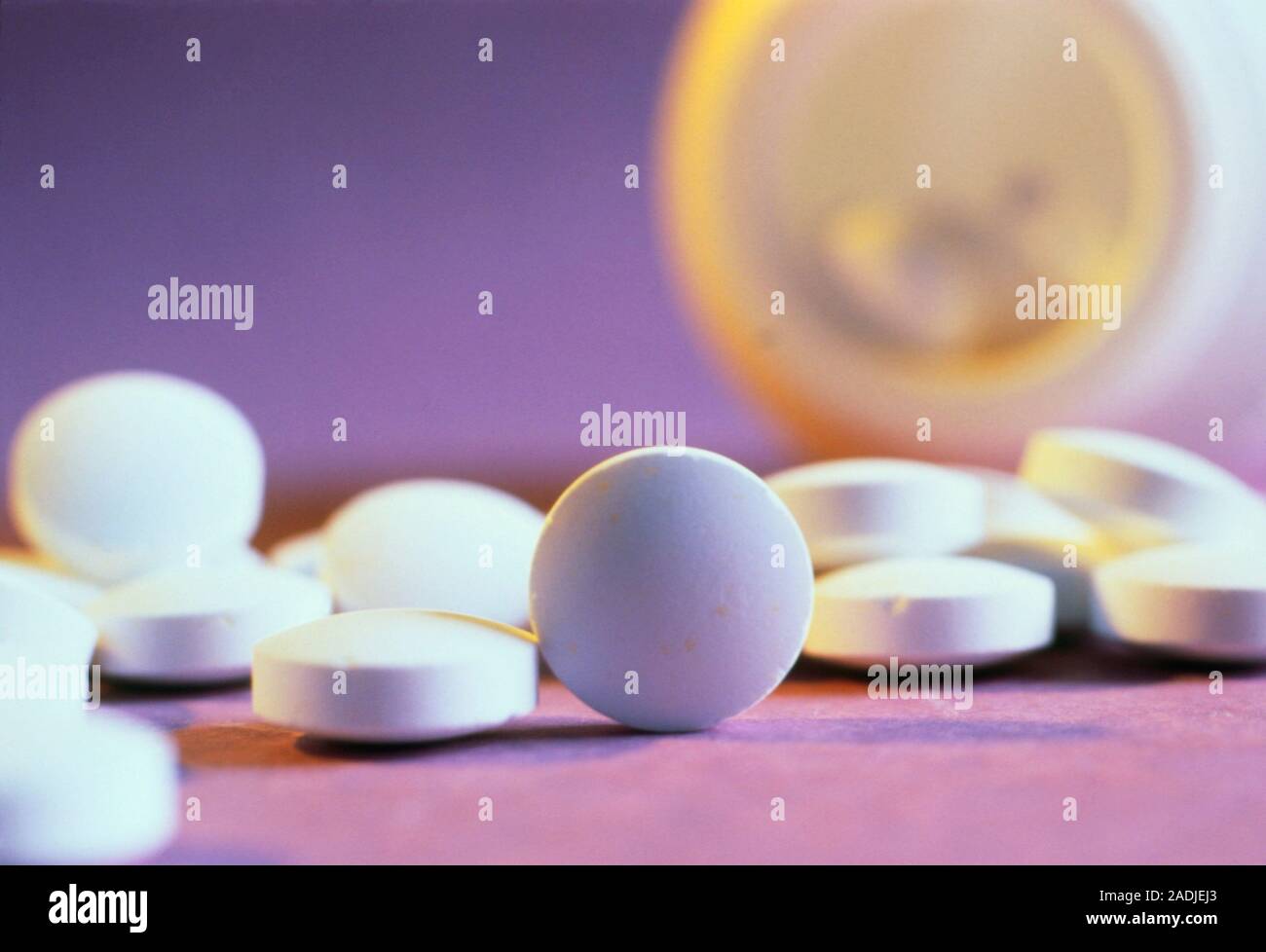 Calcium pills. Calcium pills spilling from their bottle. They are taken ...