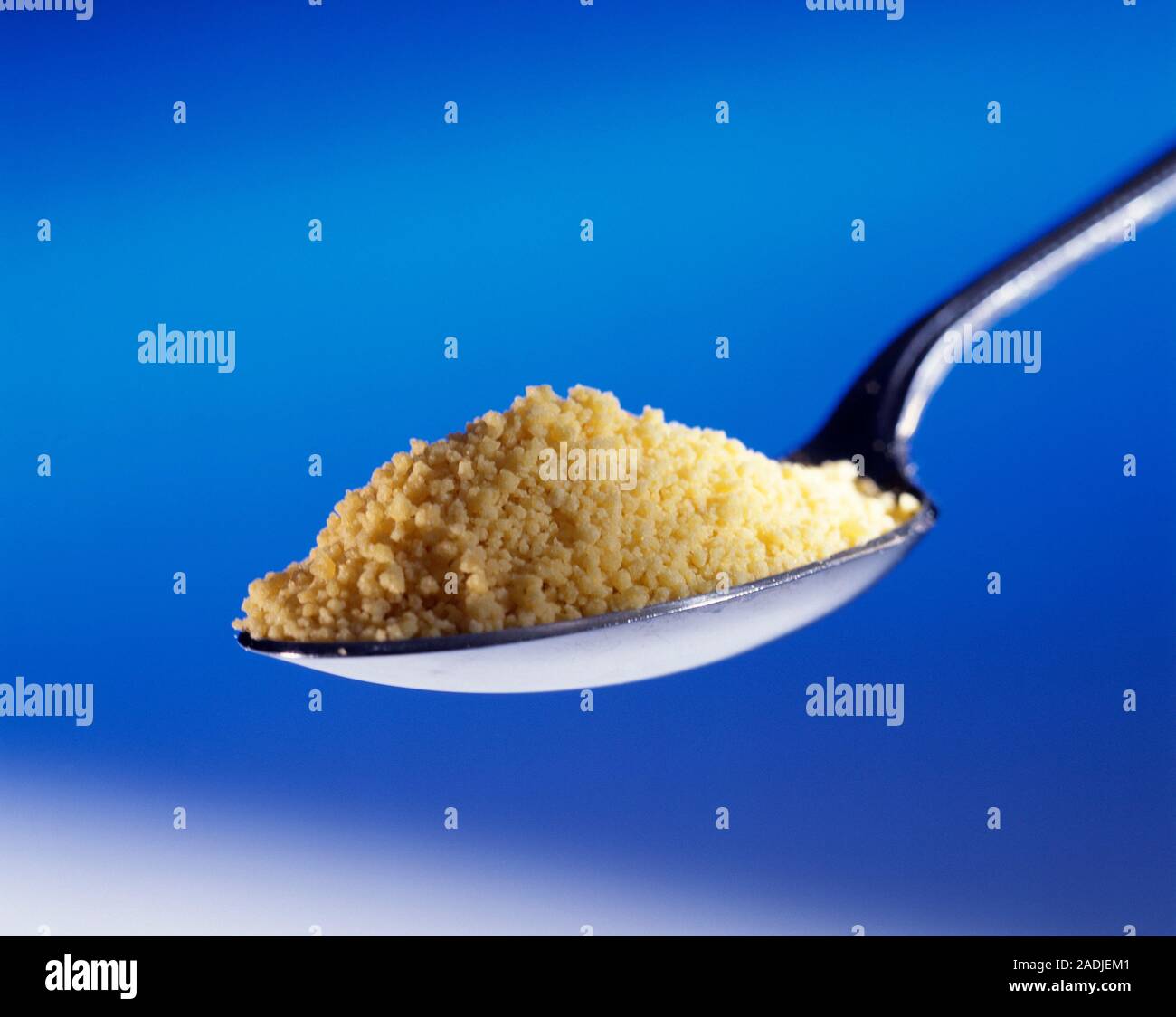 Lecithin granules on a spoon. Lecithin or phosphatidylcholine is a ...