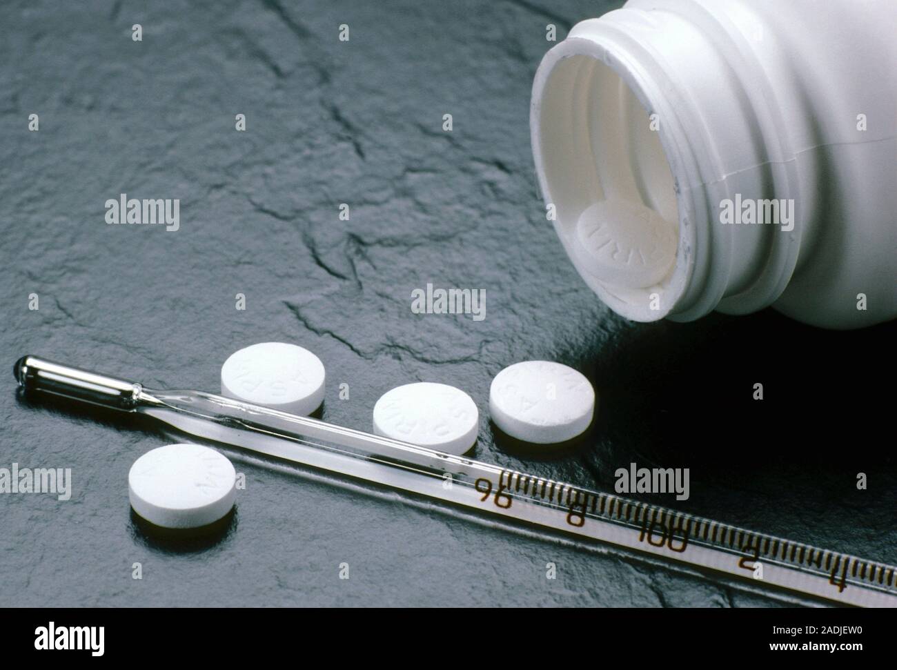 Aspirin. Container of aspirin (acetylsalicylic acid) tablets, and a ...