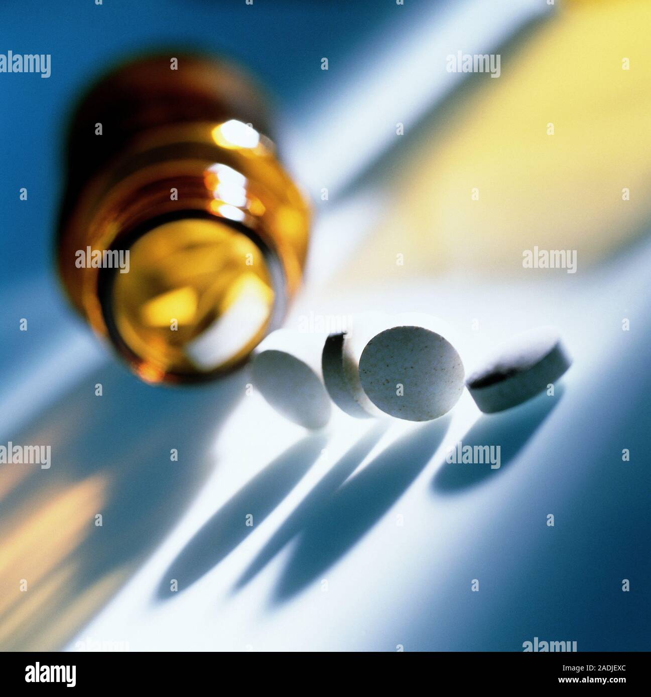 Pain killers. View of pain killer pills spilling out of a bottle. The ...