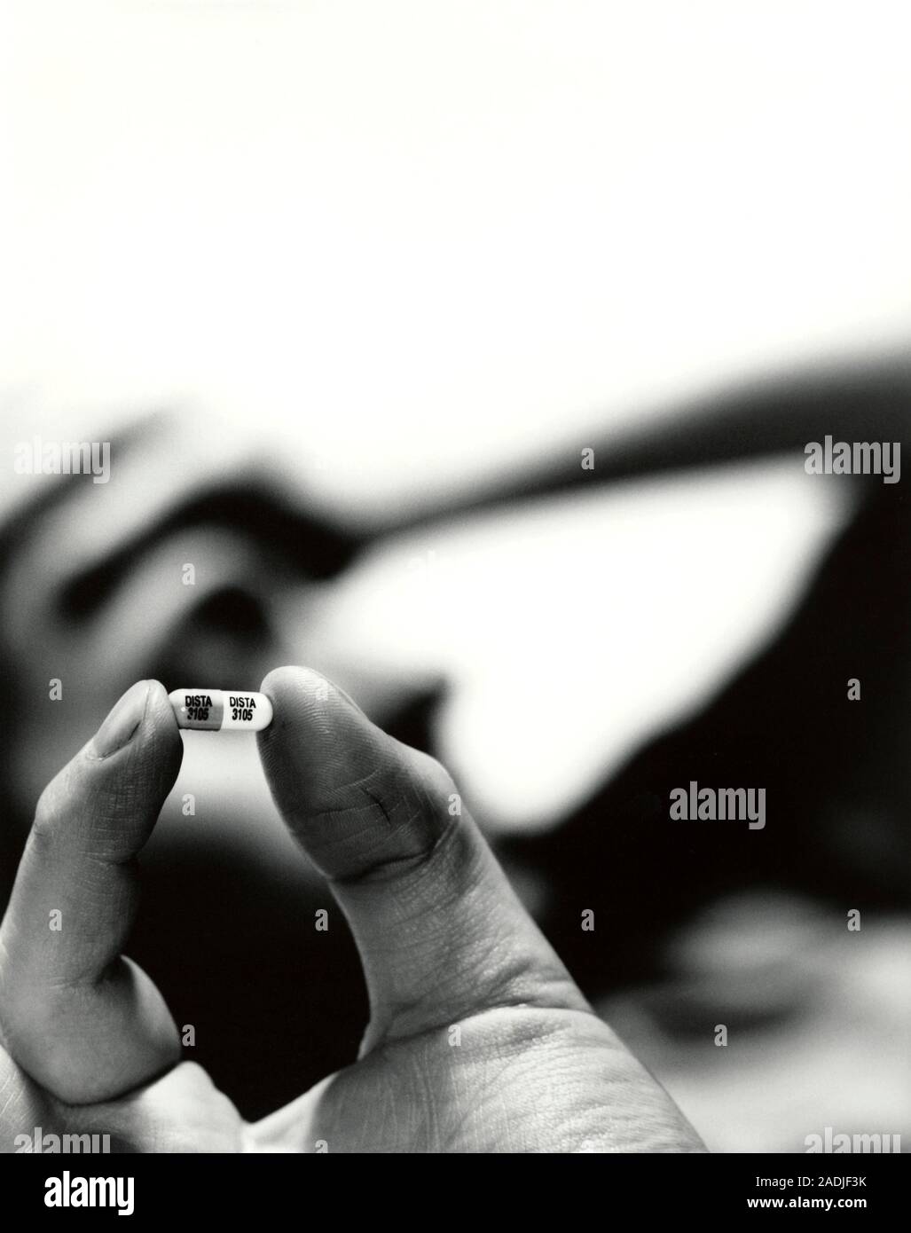 Antidepressant capsule. Fingers holding a capsule printed with DISTA ...